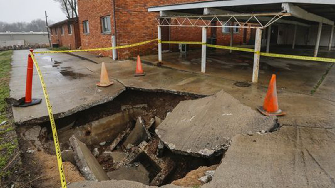 Trash truck plummets 10 feet into collapsed septic tank in Springfield ...