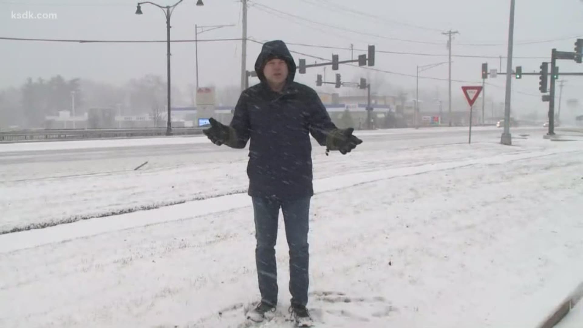 Meteorologist Scott Connell shows the snowy conditions in Ballwin ...