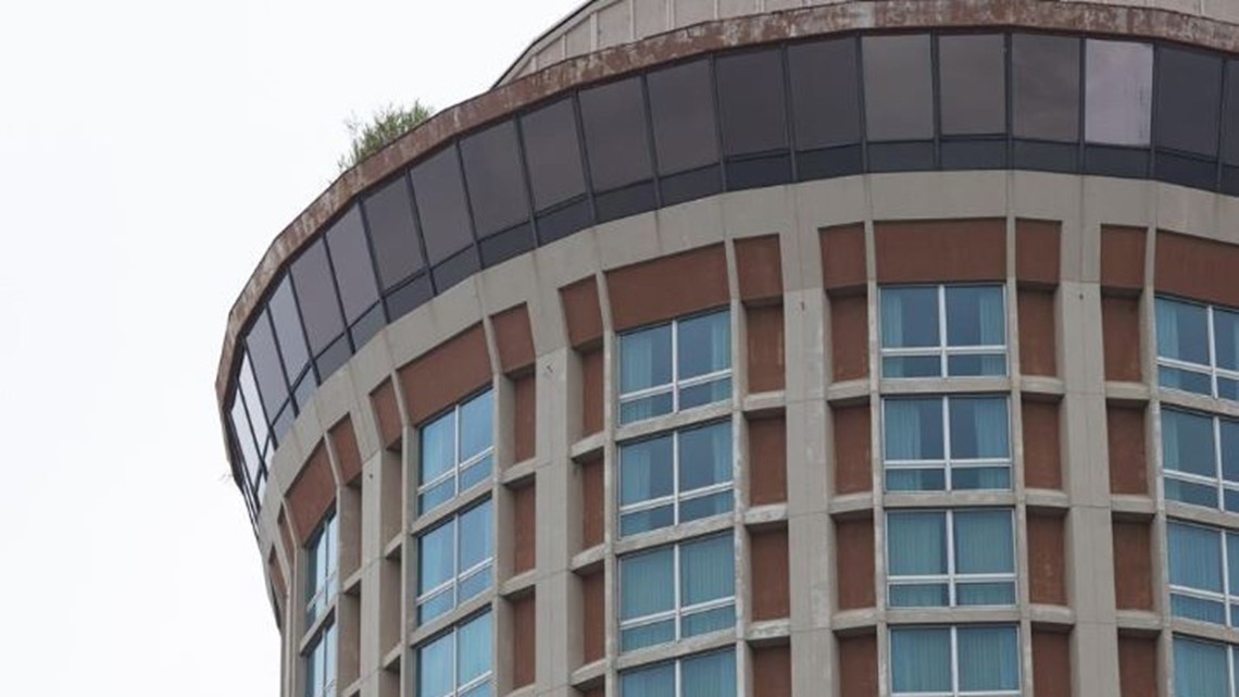 Millennium Hotel cited for weeds, graffiti, shot-out window | ksdk.com